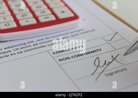 An auditor giving signature at audit report and checked it with the ...