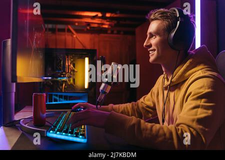 Gamer stream concept, Male streamer typing on keyboard to chat with ...