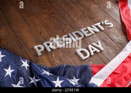words presitdents day laid with silver letters on wooden surface near ...