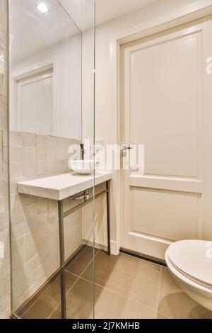 White ceramic toilet and shower placed in light stylish bathroom at ...
