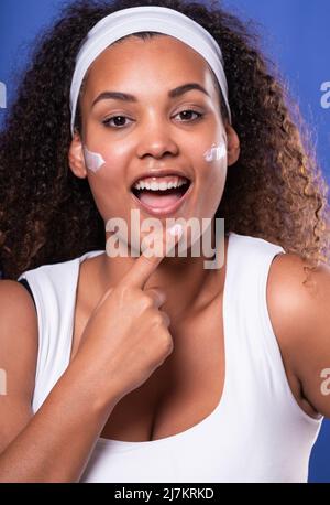 Smiling woman with moisture cream Stock Photo - Alamy
