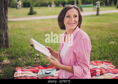 Photo of sweet dreamy woman dressed plaid shirt working modern device ...