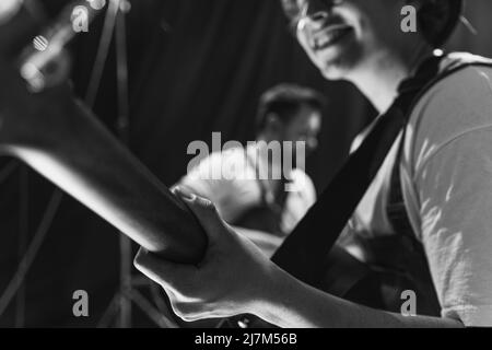 Repetition of rock music band. Cropped image of electric guitar player ...