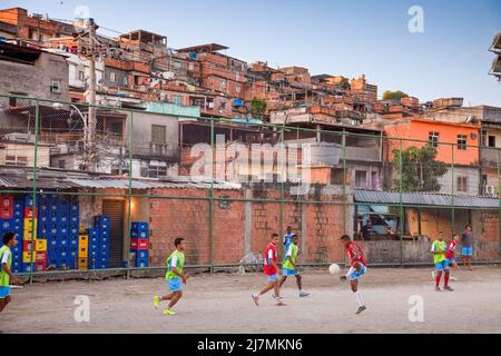 Brazil, Rio de Janeiro, children on a soccer field in one of the many ...