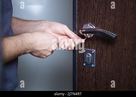 Hex key and installation of door lock and handle, close-up installation ...