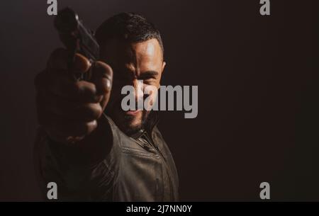 Man shooting firearm handgun, makarov pistol in a firing range ...