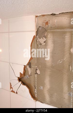 Breaking ceramic tiles, work in progress, maintenance Stock Photo - Alamy