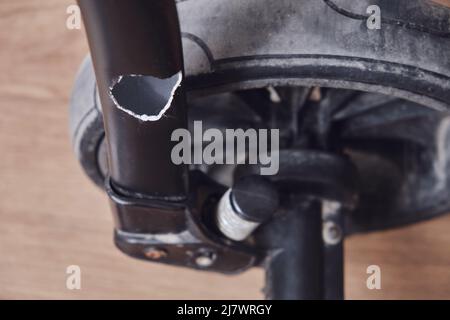 Broken chassis of a baby stroller, damage to the crossbar of the metal ...