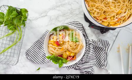 Flat lay. Step by step. Serving a one-pot pasta into a white pasta ...