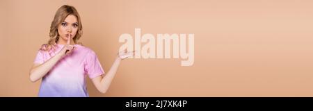 Pretty young woman showing a hush sign Stock Photo - Alamy