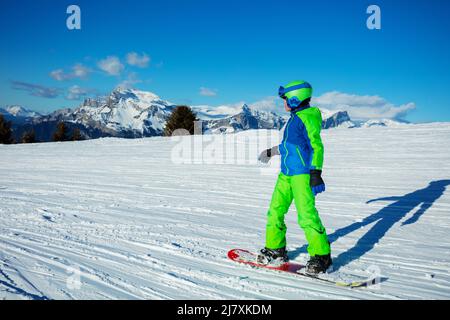 Snowboarder boy go downhill on snowboard from mountain top Stock Photo ...