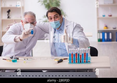 Two chemists working at the lab during pandemic Stock Photo - Alamy