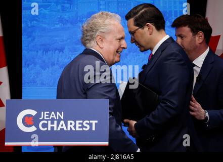 Jean Charest, left, and Pierre Poilievre shake hands following the ...