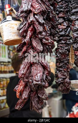 Bunch of dried pimento paprika hanging on farmers market in Spain Stock ...
