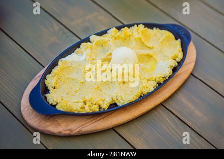Traditional Montenegrin Meal. Kacamak in a black pan Stock Photo - Alamy
