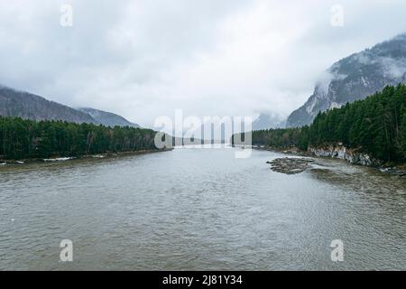 Morning Fog on the Mountain Lake with Dock Covered with Snow. Winter ...