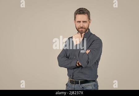 Without compromising on style. Middle-aged man touch bearded chin ...