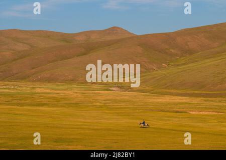Lone Mongolian horseback rider travels through grasslands, Bogd Khan ...