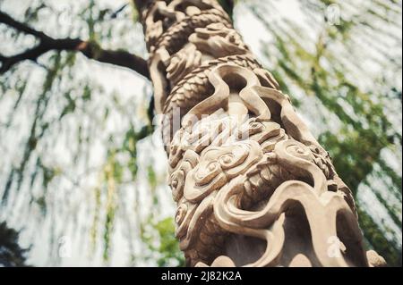 Chinese dragon pillar stone carving column outside in Thai temple ...