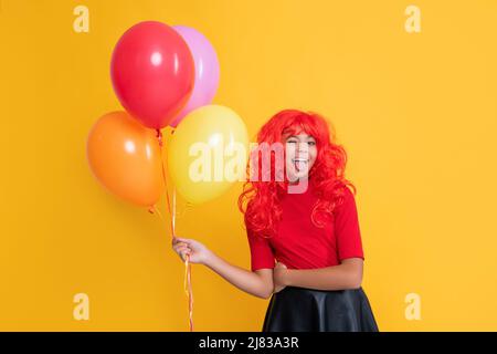 winking redhead girl with curly hair on blue background Stock Photo - Alamy