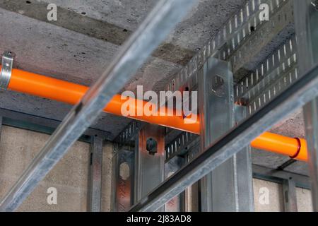 Orange Fire Sprinkler Pipes above freshly installed galvanized steel ...