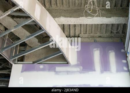 Overhead installed ceiling drywall or sheetrock showing galvanized ...