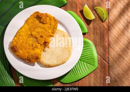 Fish torta with arepa - Colombian street food Stock Photo - Alamy