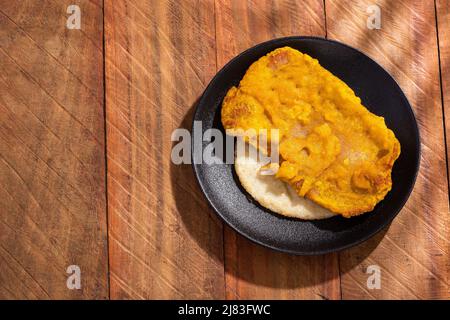 Breaded fish fillet - Traditional Colombian food Stock Photo - Alamy