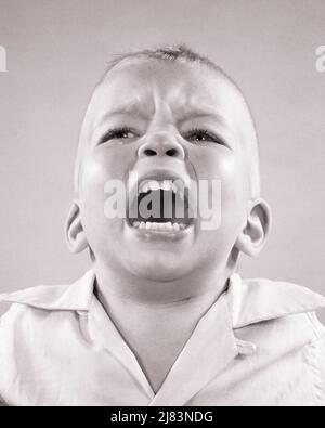 a portrait of toddler boy with angry upset face expression Stock Photo ...