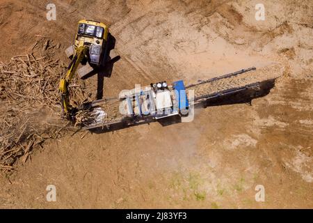 An industrial wood chipper at work with roots for grinding machine to ...