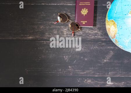 World map and items on wooden background, flat lay. summer travel ...