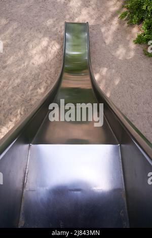 Metal spiral playground slide Stock Photo - Alamy