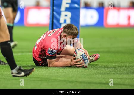 Matty Nicholson #30 of Wigan Warriors goes over for a try on his debut ...