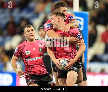 Matty Nicholson #30 of Wigan Warriors goes over for a try on his debut ...