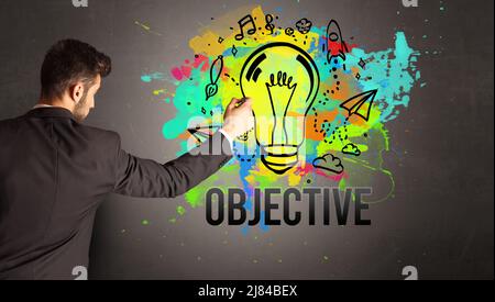 businessman drawing colorful light bulb Stock Photo - Alamy