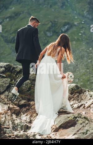 A view from above on the wedding couple standing in the end of wooden ...