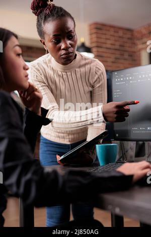 African american software developer pointing out cloud database processing algorithm error ...