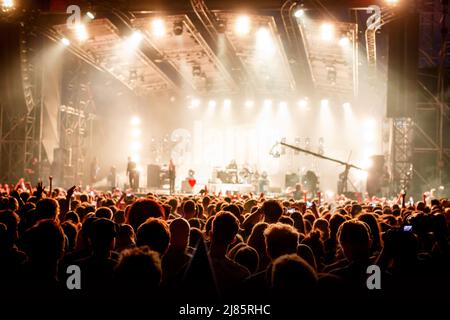 Crowd at concert - Cheering crowd in bright colorful stage lights Stock ...