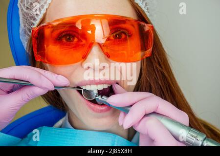 Dental drilling procedure and check up on beautiful teeth and open ...
