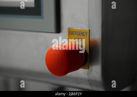 big red button in a factory. yellow base, red button and green light on ...