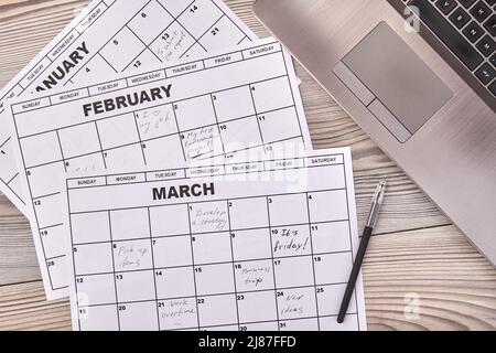 Paper calendars with pen and laptop pc. White desk background Stock ...