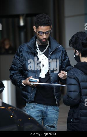 Rapper PnB Rock signs an autograph for a fan before he enters the Four ...