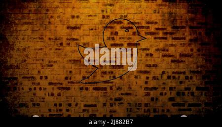 Image of glowing neon bird icon on brick wall. social media and ...
