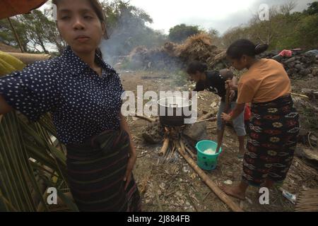Women boiling water as a preparation for a ritual of house construction ...