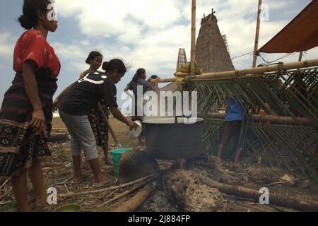 Women boiling water as a preparation for a ritual of house construction ...