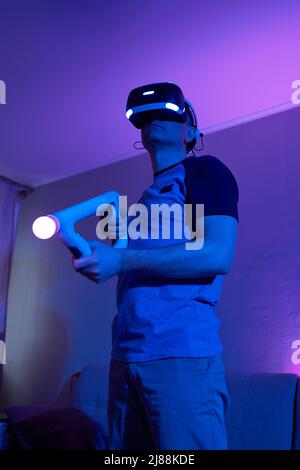 Man with virtual reality headset and joystic is playing game Concept of ...