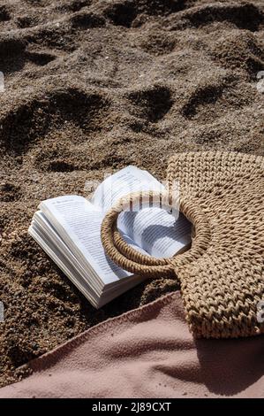 Knitted bag with beach accessories on yellow background. Space for text ...
