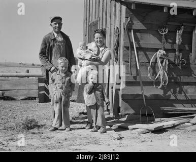 Two farm boys in overalls stand for a portrait in a field during the ...