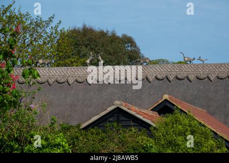 Straw finials of animals on a thatched roof Stock Photo - Alamy