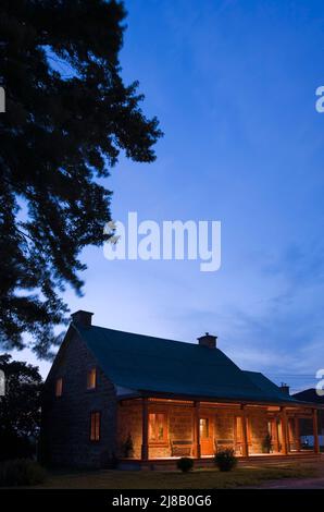 Old circa 1850 style cut stone home at dusk Stock Photo - Alamy